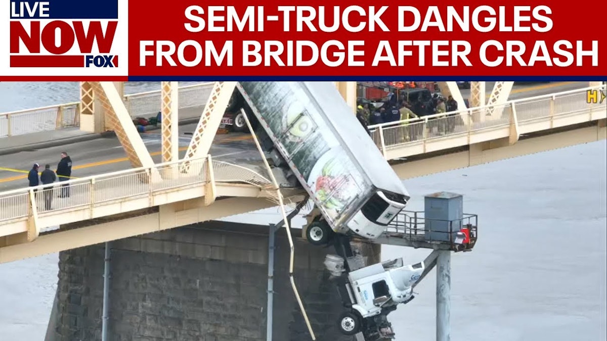 Dramatic video shows driver rescued after semi-truck dangles from ...